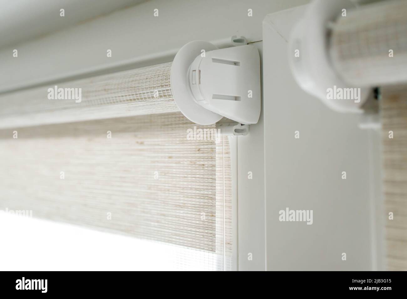 Close up mechanism of tnaninny roller blinds indoors. Duo window roller ...