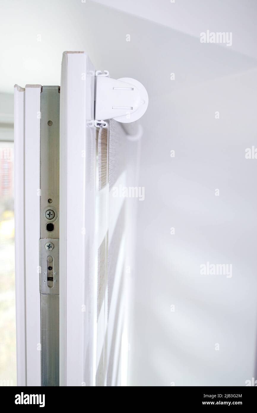 Close up mechanism of tnaninny roller blinds indoors. Duo window roller ...