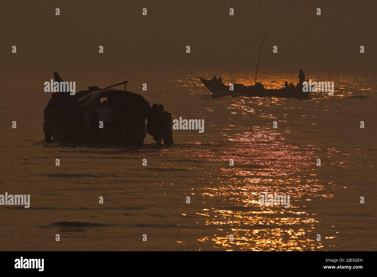 Fishing boats stream in the river. Dhal Char, Vola, Bangladesh. January ...