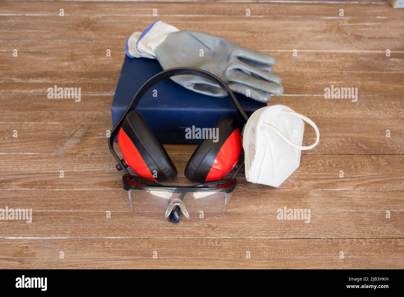 Image of gloves, goggles, headphones, face mask and a first aid box ...