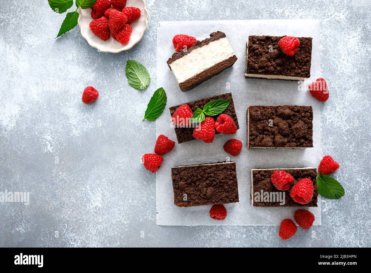 Chocolate cube cake, sliced brownie cheesecake with fresh raspberry ...