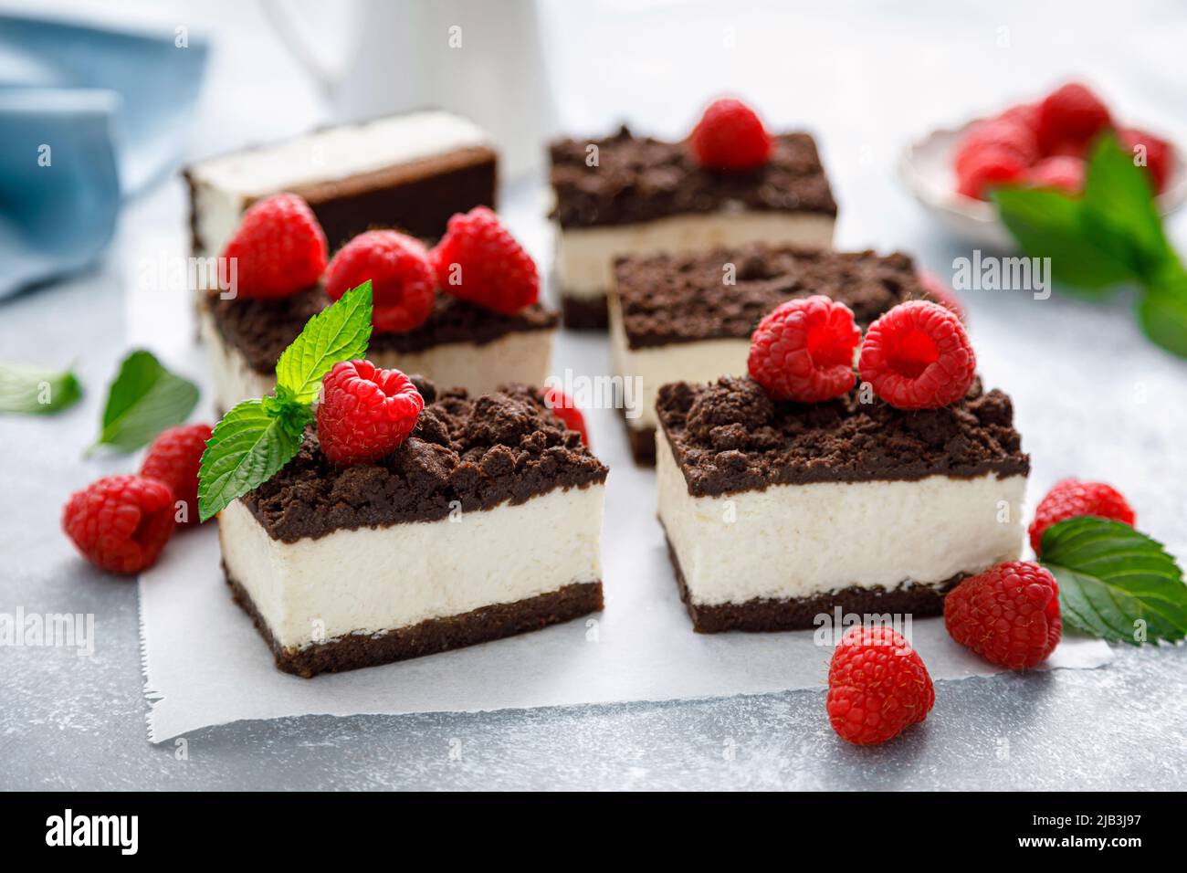 Chocolate cube cake, sliced brownie cheesecake with fresh raspberry ...