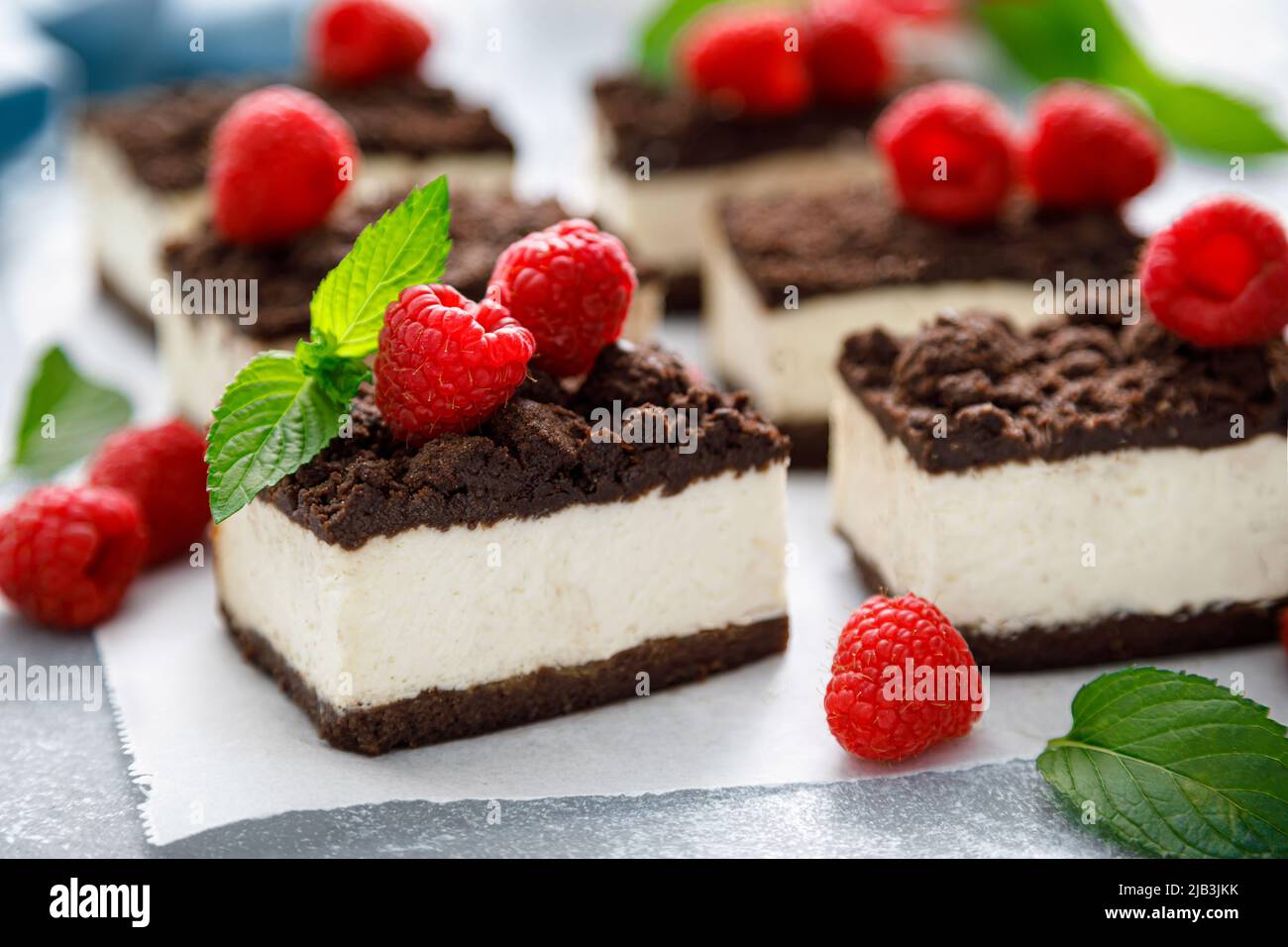 Chocolate cube cake, sliced brownie cheesecake with fresh raspberry ...