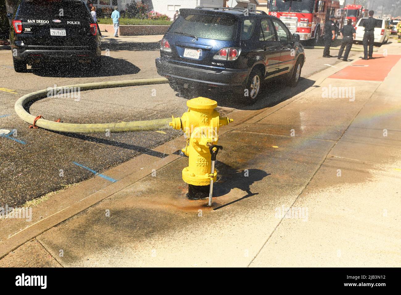 Fire hydrant sprays water at a structure fire Stock Photo - Alamy