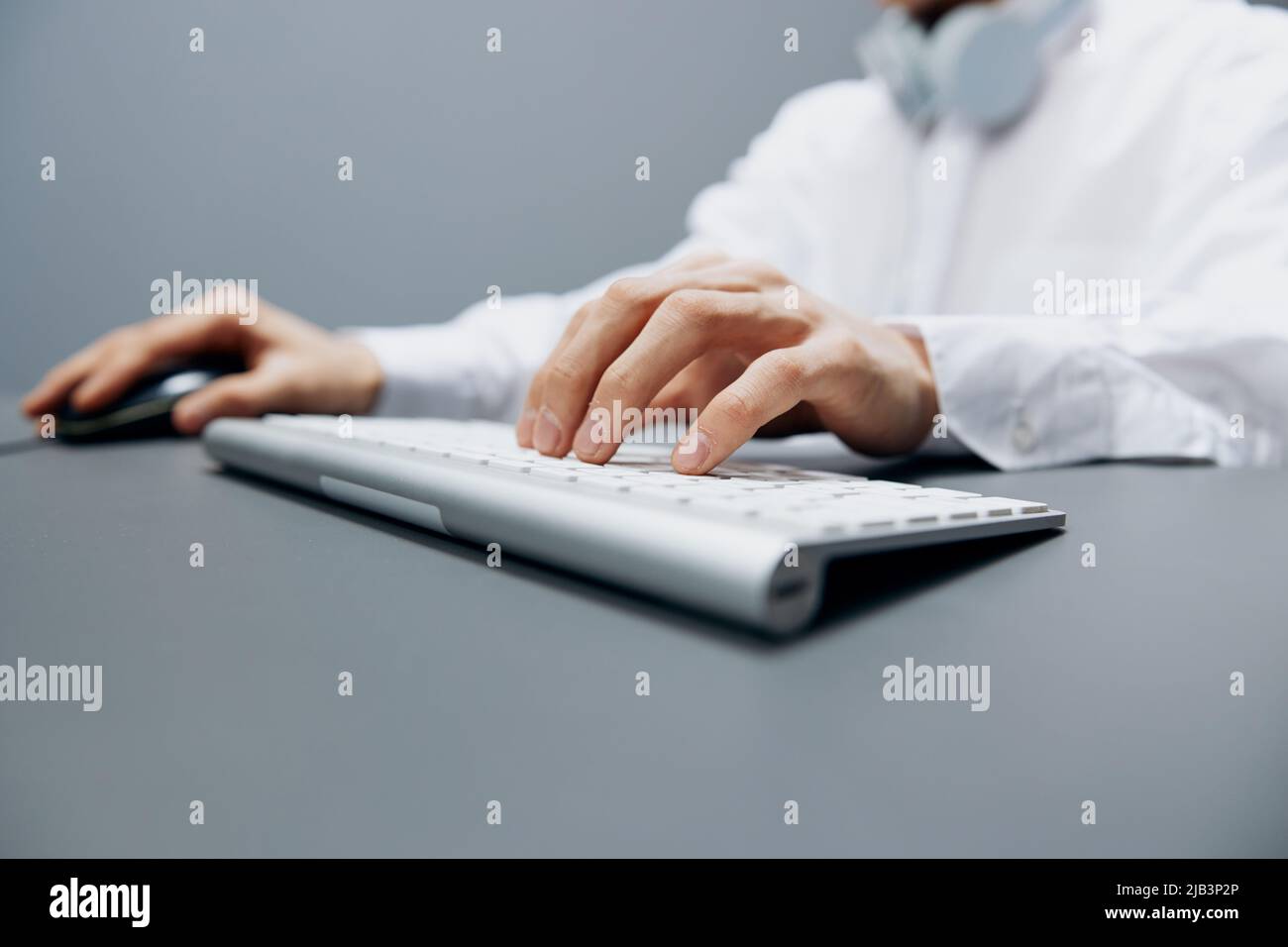 man in a white shirt keyboard work official office Gray background ...