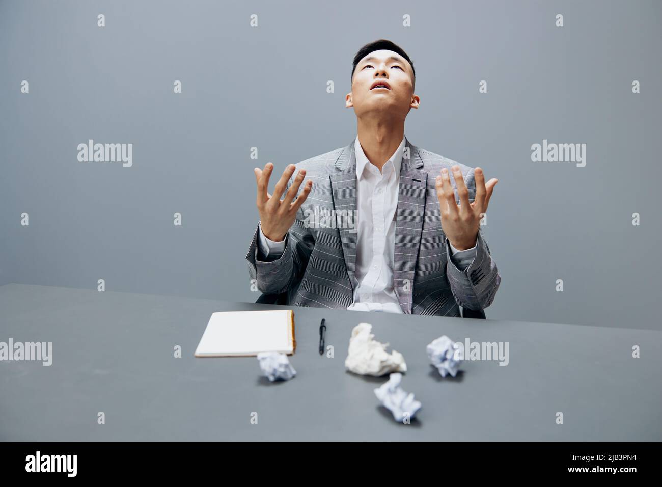 man sits in the office emotions nervous breakdown anger Gray background ...