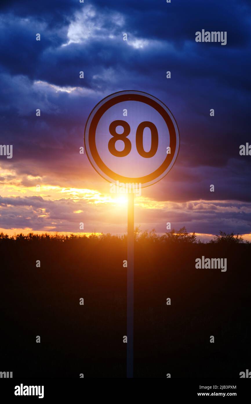 Speed limit sign of 80 km h background bright sunset and clouds Stock ...