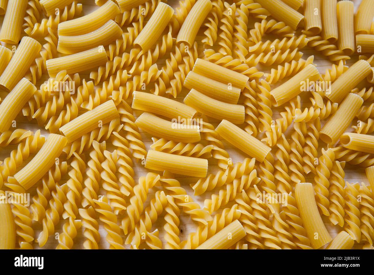 Background from macaroni fusilli and maccheroni rigati, top view. Raw ...