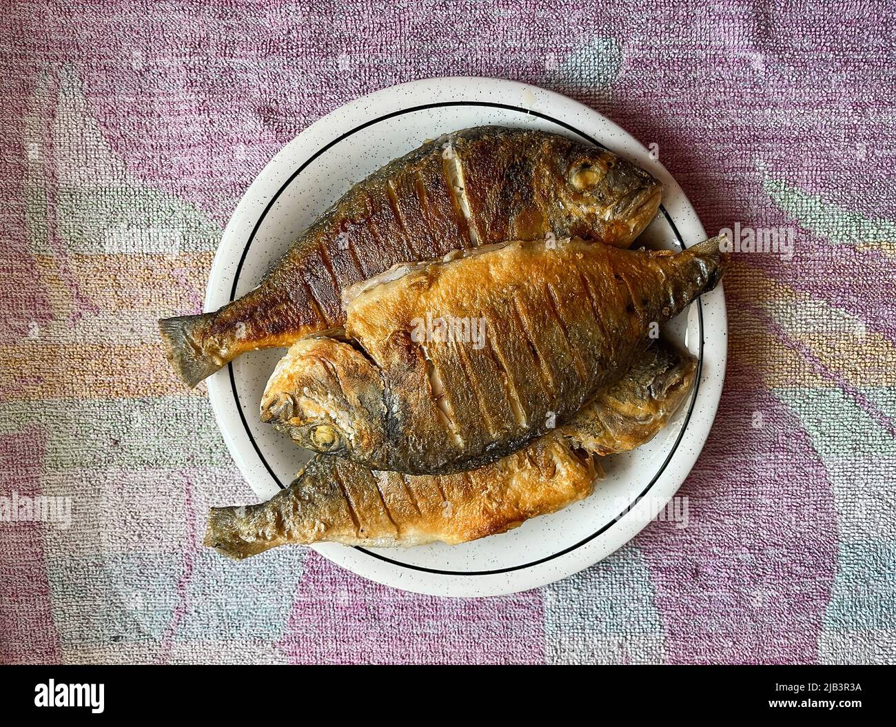 Three fried dorado fish hi-res stock photography and images - Alamy
