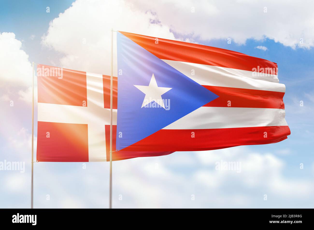 Sunny blue sky and flags of puerto rico and denmark Stock Photo - Alamy