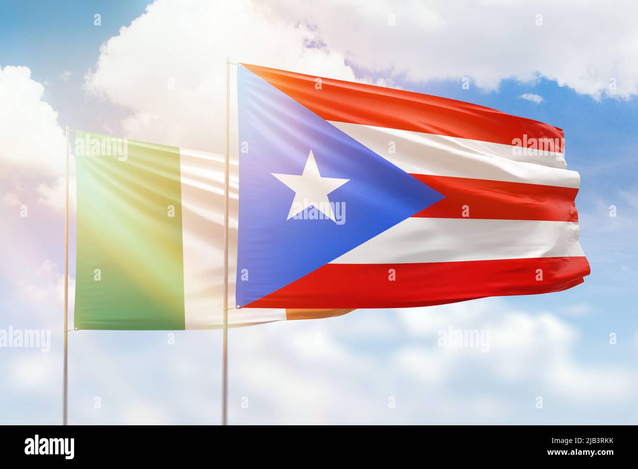 Sunny blue sky and flags of puerto rico and ireland Stock Photo - Alamy