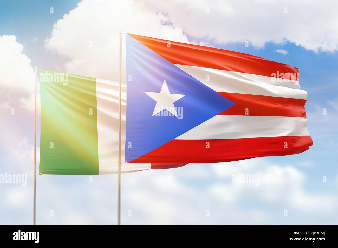 Sunny blue sky and flags of puerto rico and italy Stock Photo - Alamy