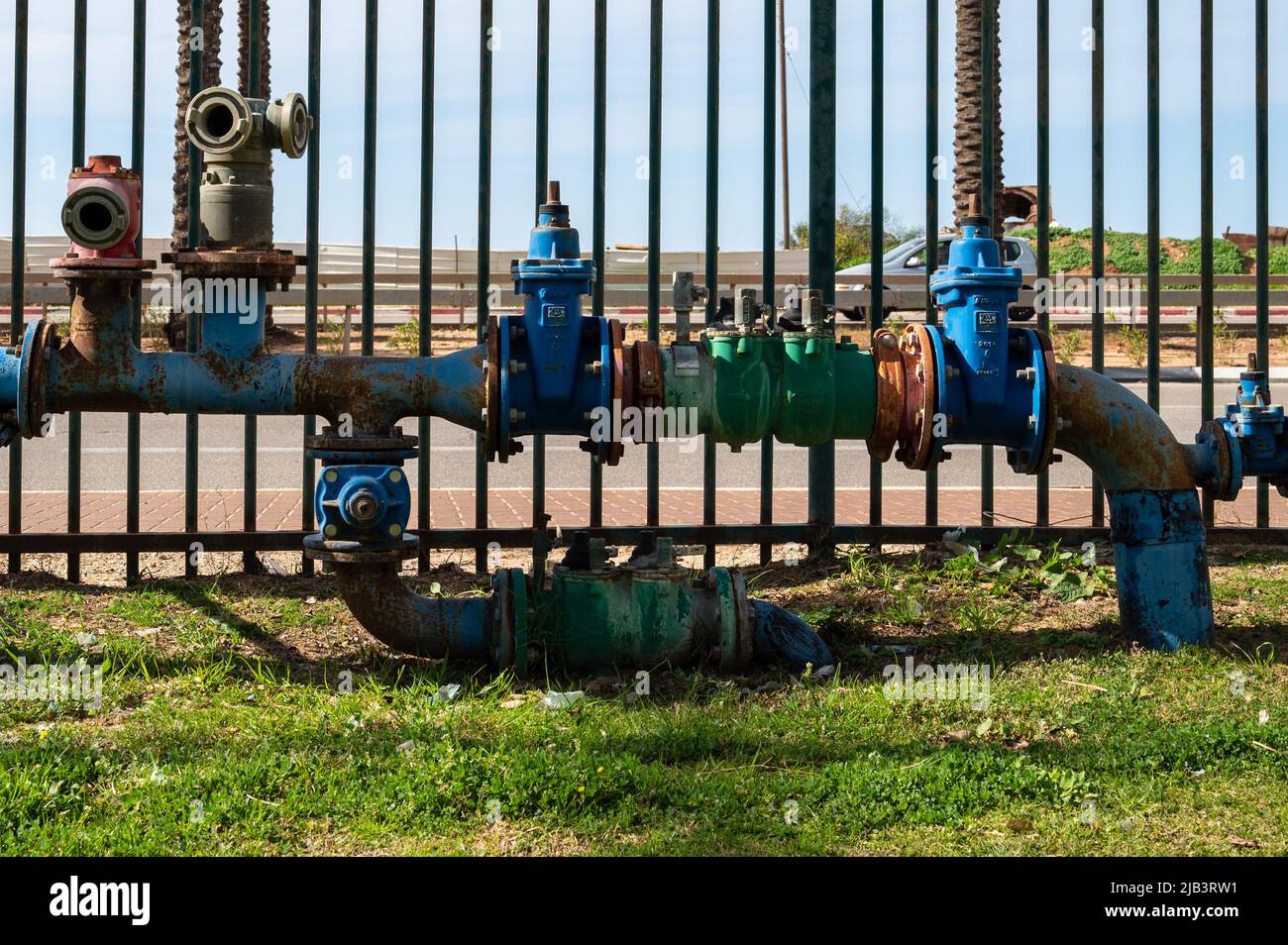 Industrial water pipes with valves and hose connections are located ...