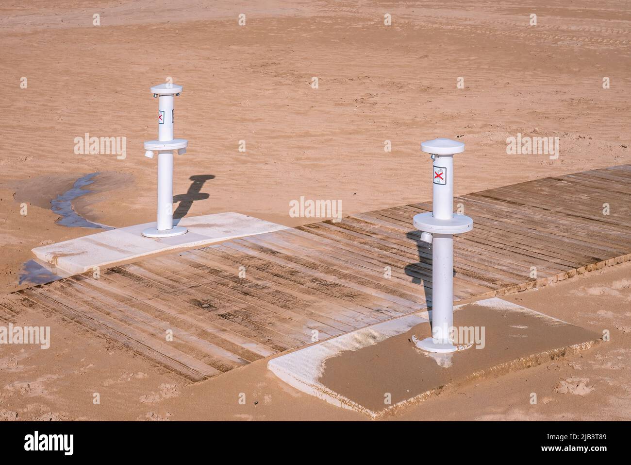 Two beach showers for feet cleaning from beach sand Stock Photo - Alamy