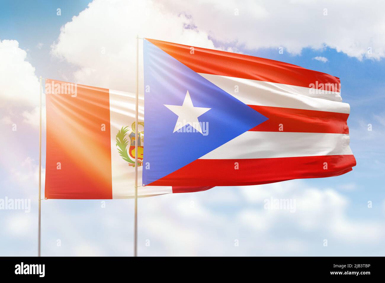 Sunny blue sky and flags of puerto rico and peru Stock Photo - Alamy