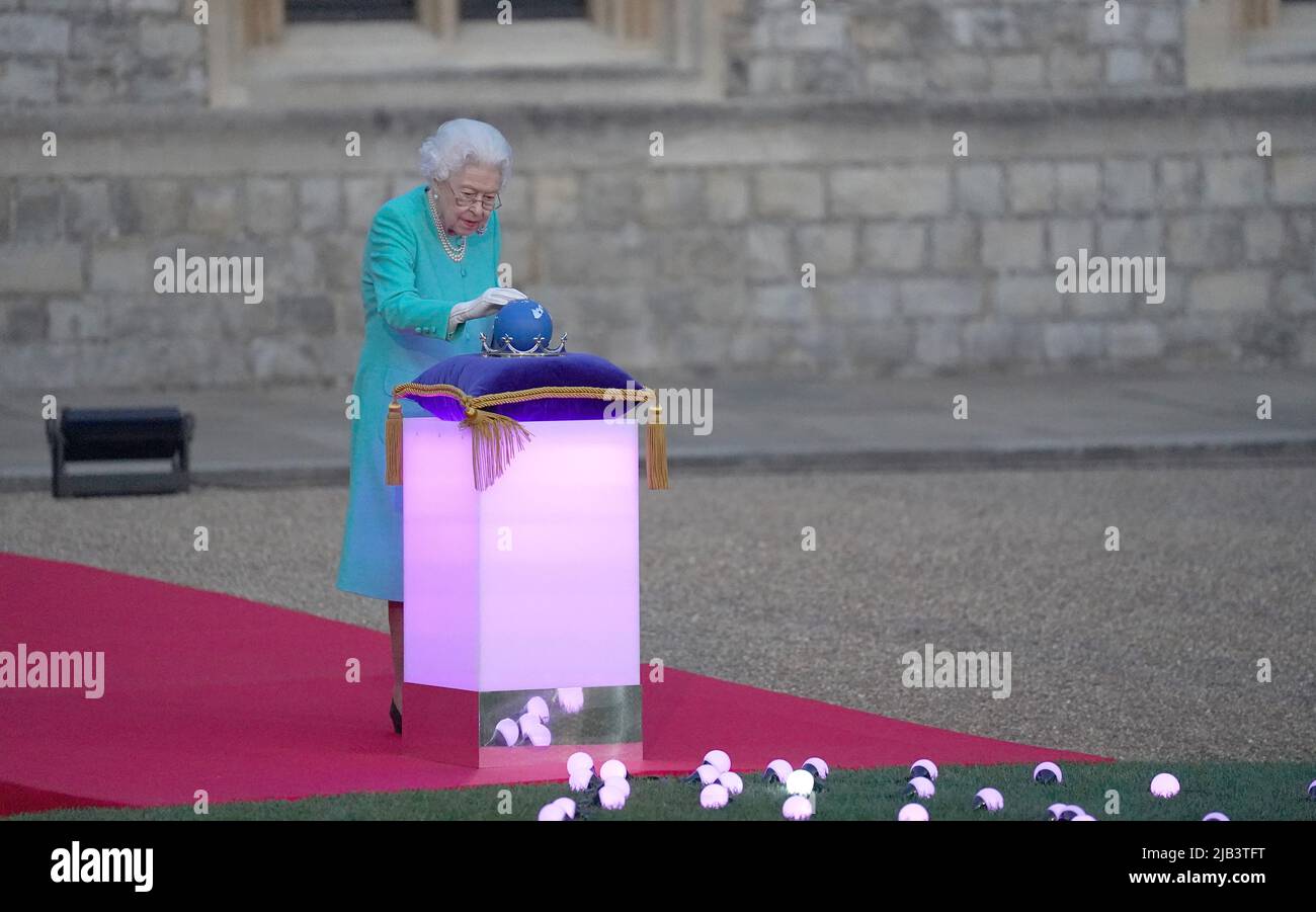 Queen Elizabeth II symbolically leads the lighting of the principal ...