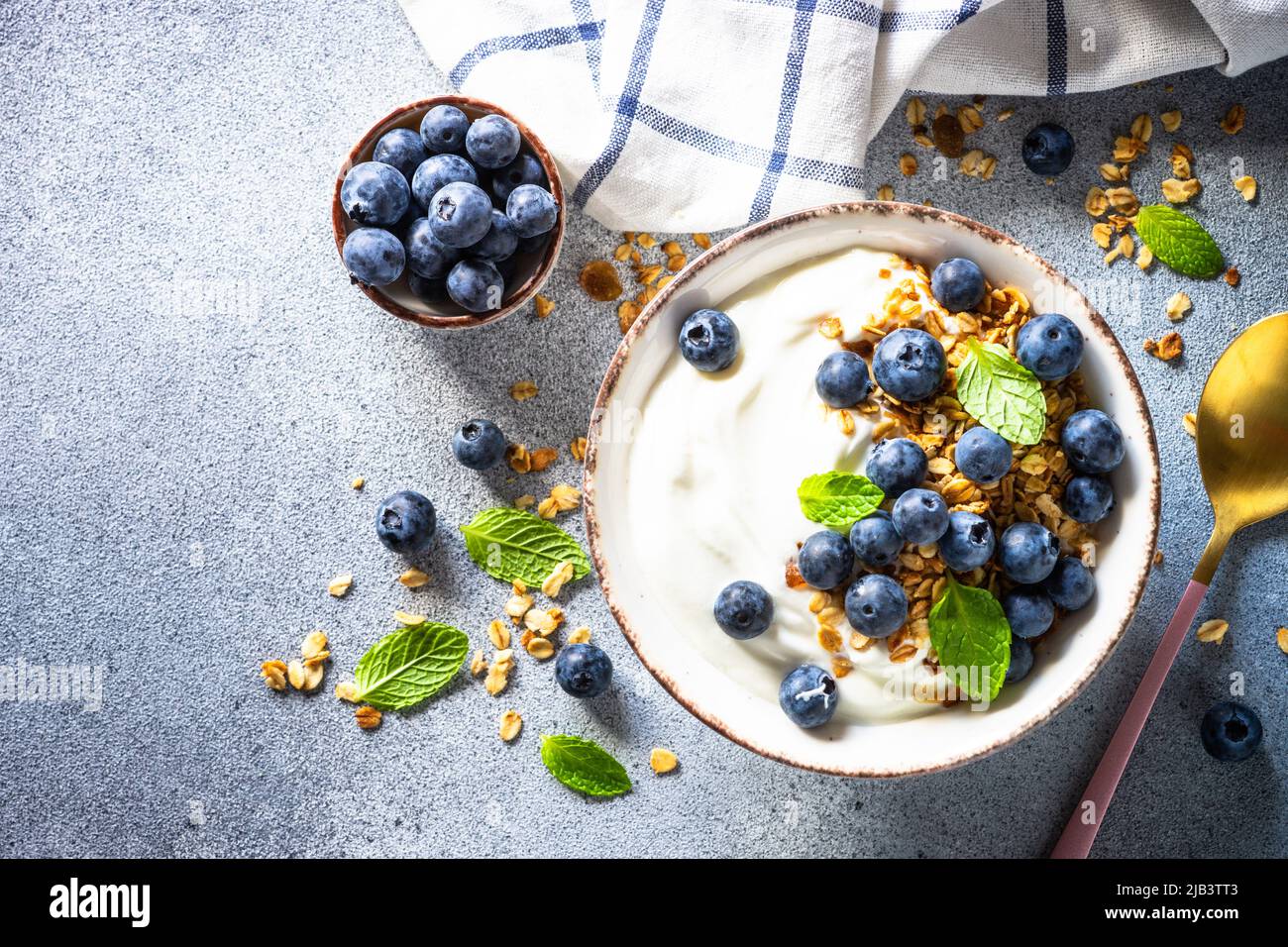 Greek Yogurt, granola and blueberry at light stone table Stock Photo ...