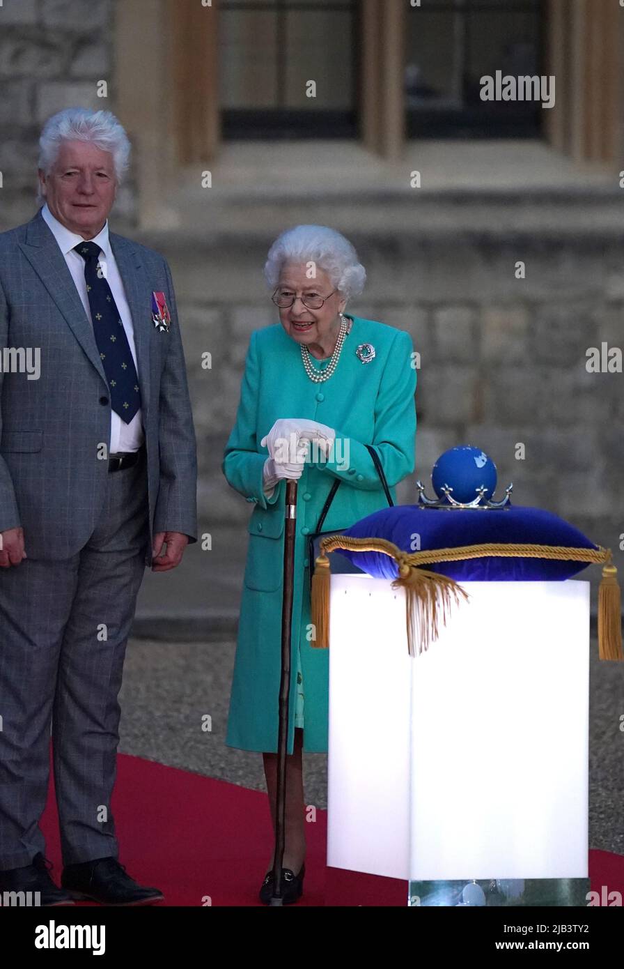 Queen Elizabeth II , with Bruno Peek, symbolically leads the lighting ...