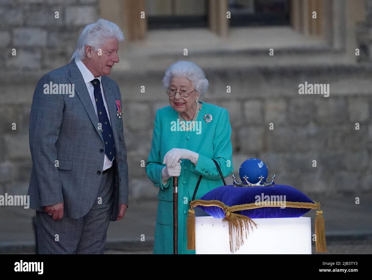 Queen Elizabeth II , with Bruno Peek, symbolically leads the lighting ...