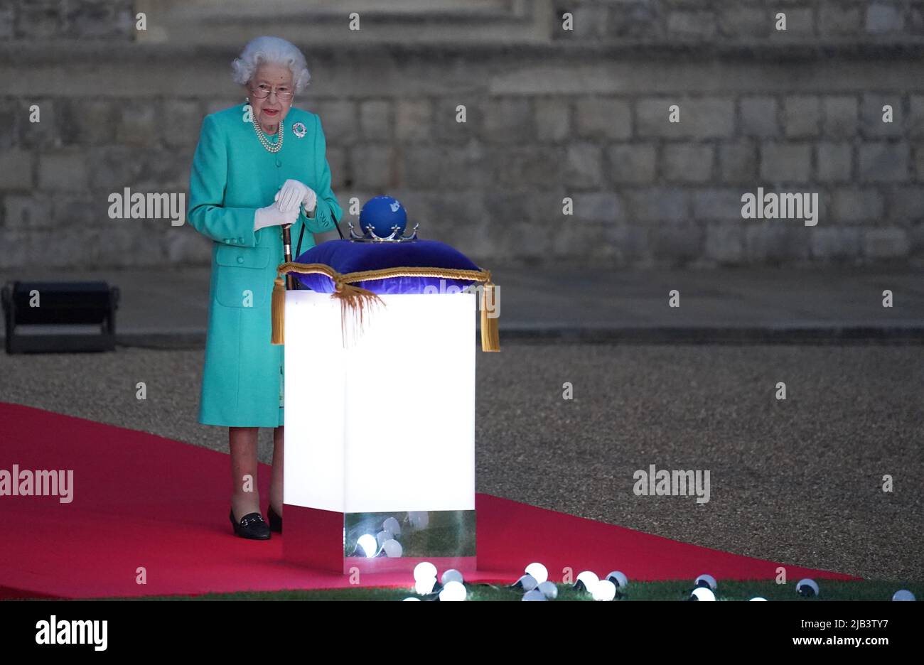 Queen Elizabeth II symbolically leads the lighting of the principal ...