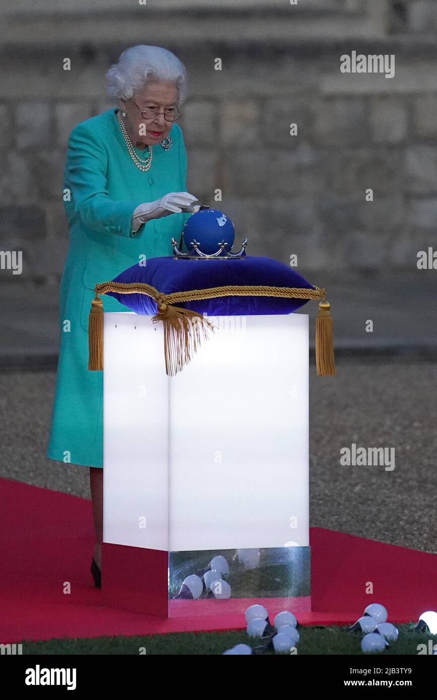 Queen Elizabeth II symbolically leads the lighting of the principal ...