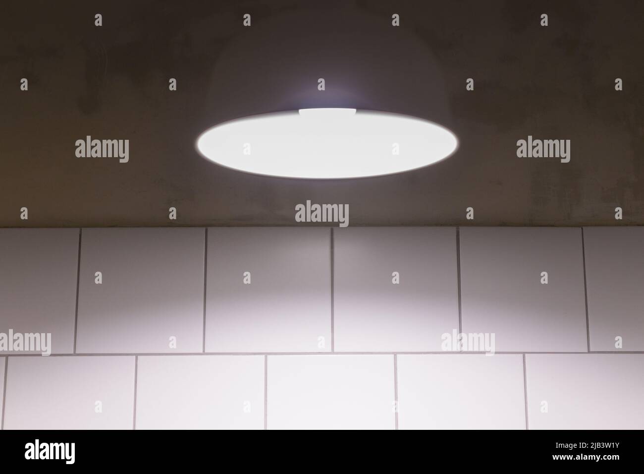 White lamp on a minimalist tile wall background Stock Photo - Alamy