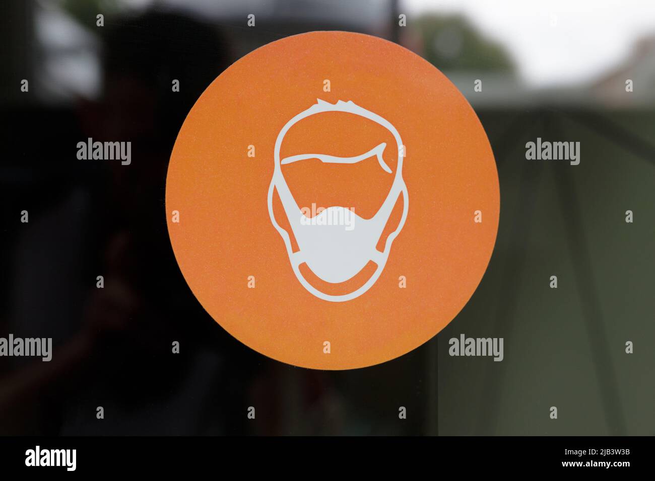Sticker on the glass door entrance only in a mask Stock Photo - Alamy