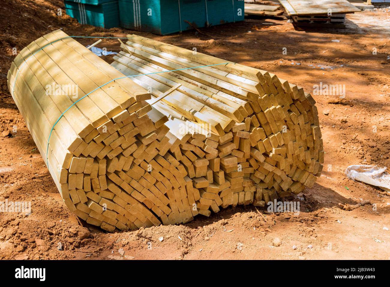 Stack of unloading wooden beams on construction building from beam ...
