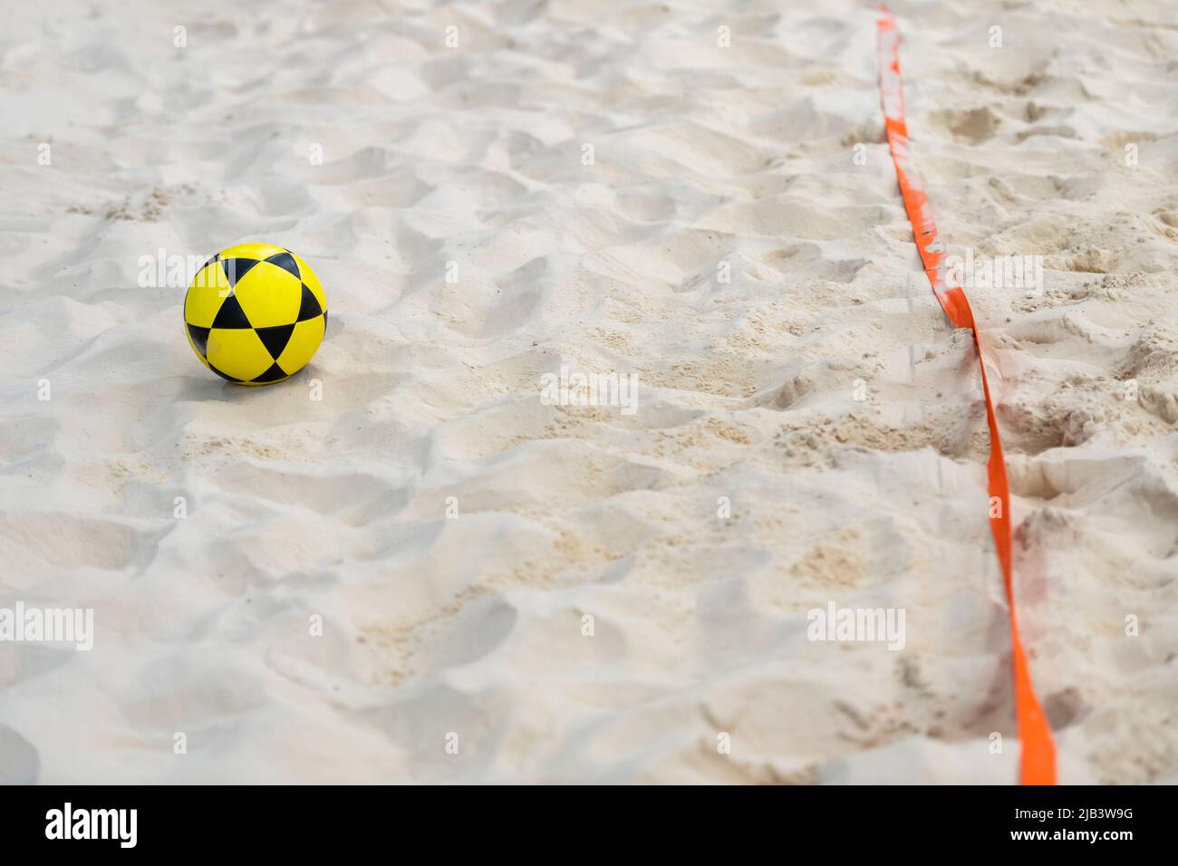 Footvolley ball with orange line on sand. Professional sport concept ...