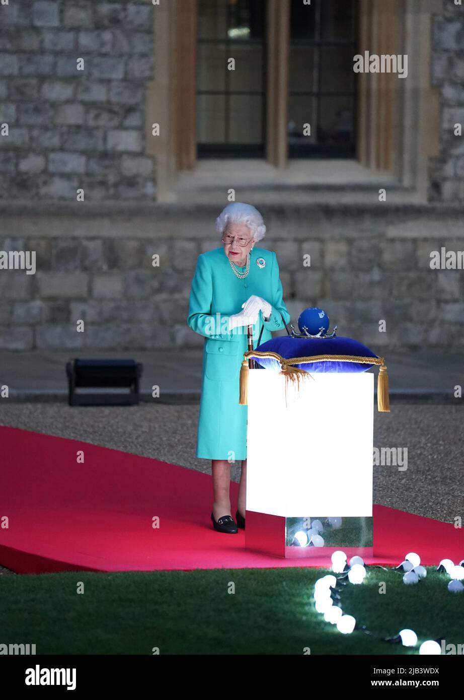 Queen Elizabeth II symbolically leads the lighting of the principal ...