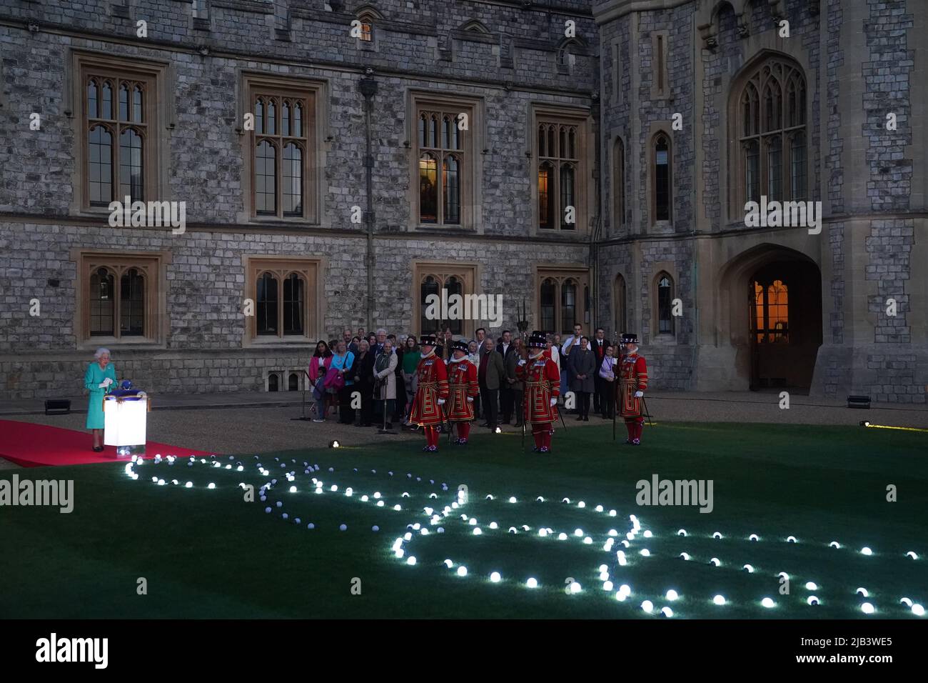 Queen Elizabeth II , with Bruno Peek, symbolically leads the lighting ...