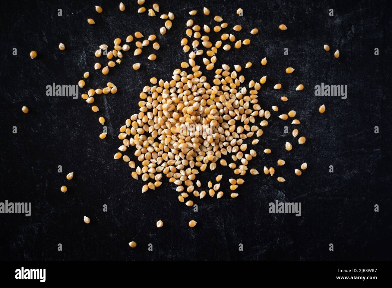 Top view of corn kernels on dark moody background Stock Photo - Alamy