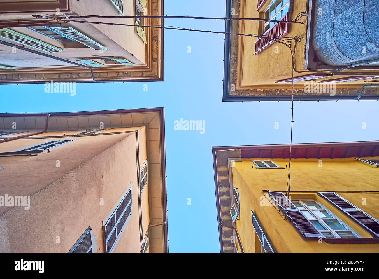 Thre view up on the cross-shaped gap between the houses in old town ...