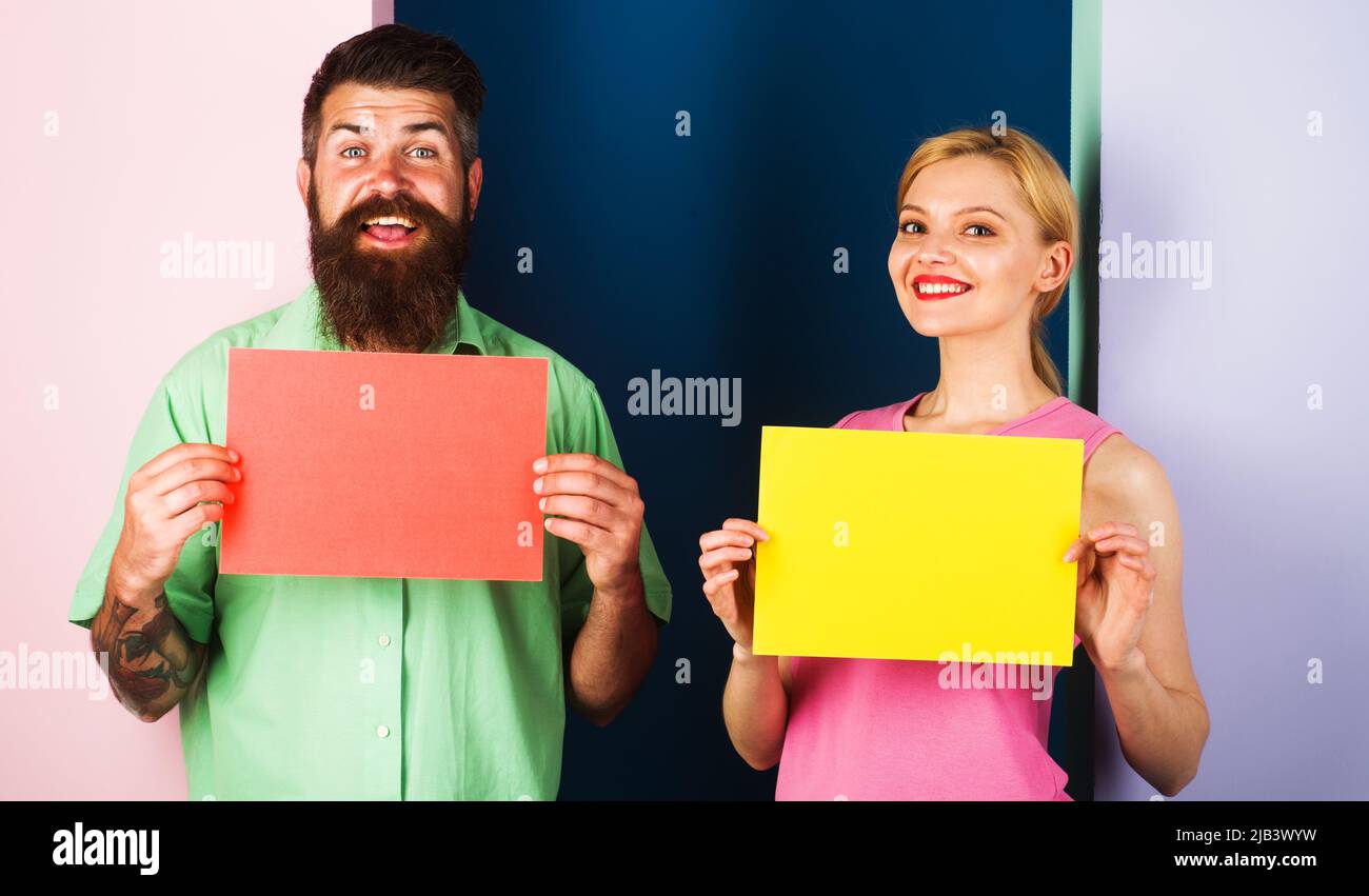 Smiling couple presenting empty advertising message board. Discount ...