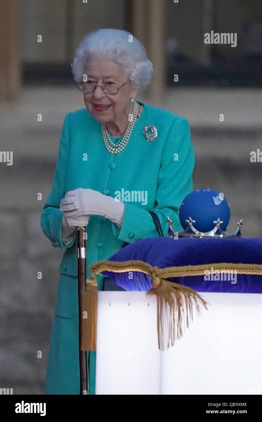Queen Elizabeth II symbolically leads the lighting of the principal ...