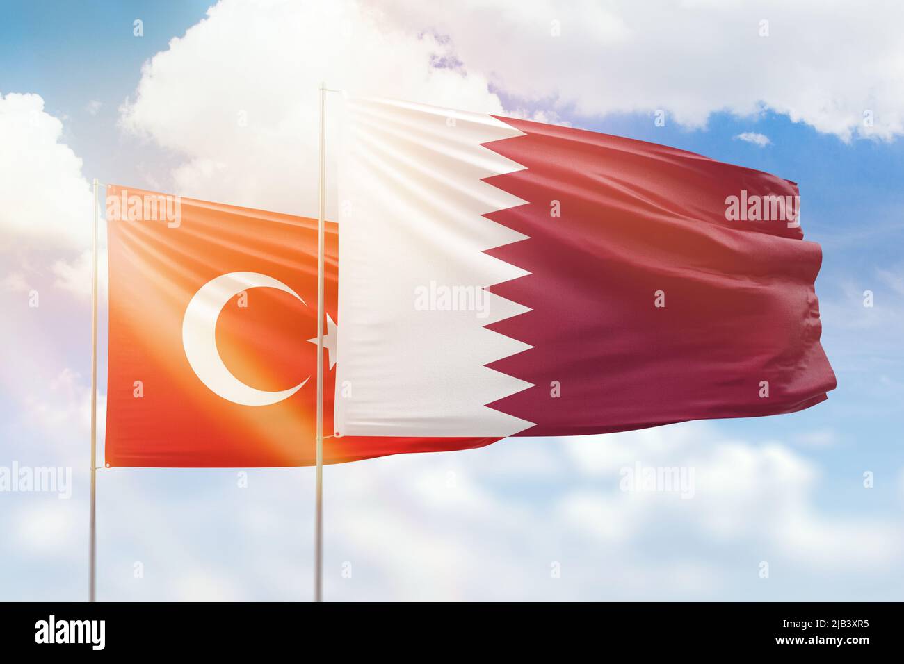 Sunny blue sky and flags of qatar and turkey Stock Photo - Alamy