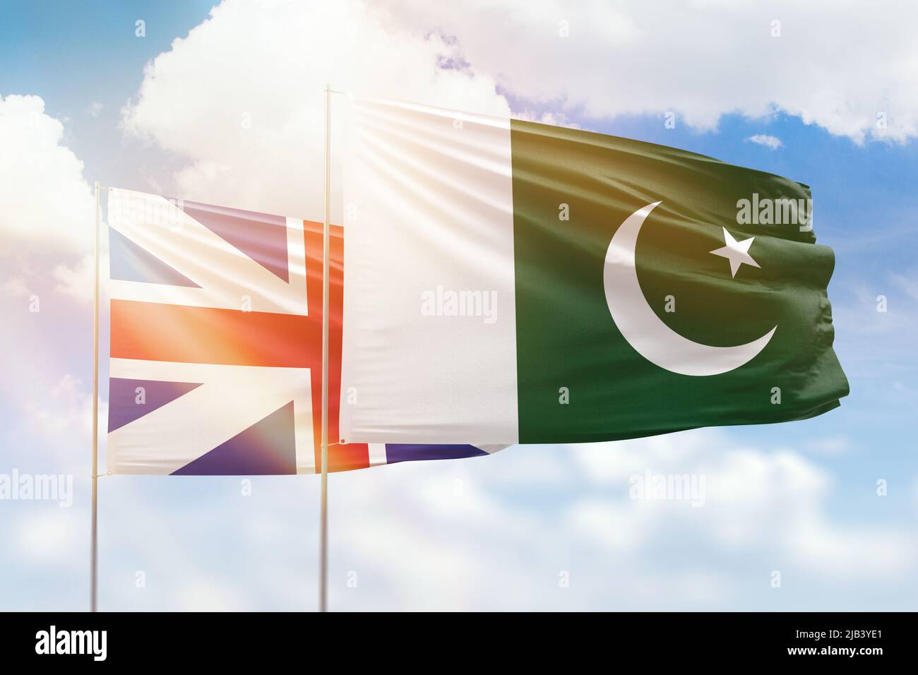 Sunny blue sky and flags of pakistan and great britain Stock Photo - Alamy