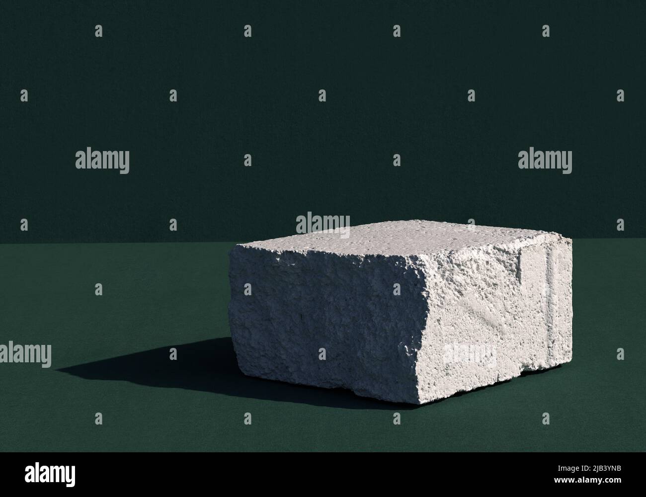 Close-up of stone or concrete brick lit by bright light and casting ...