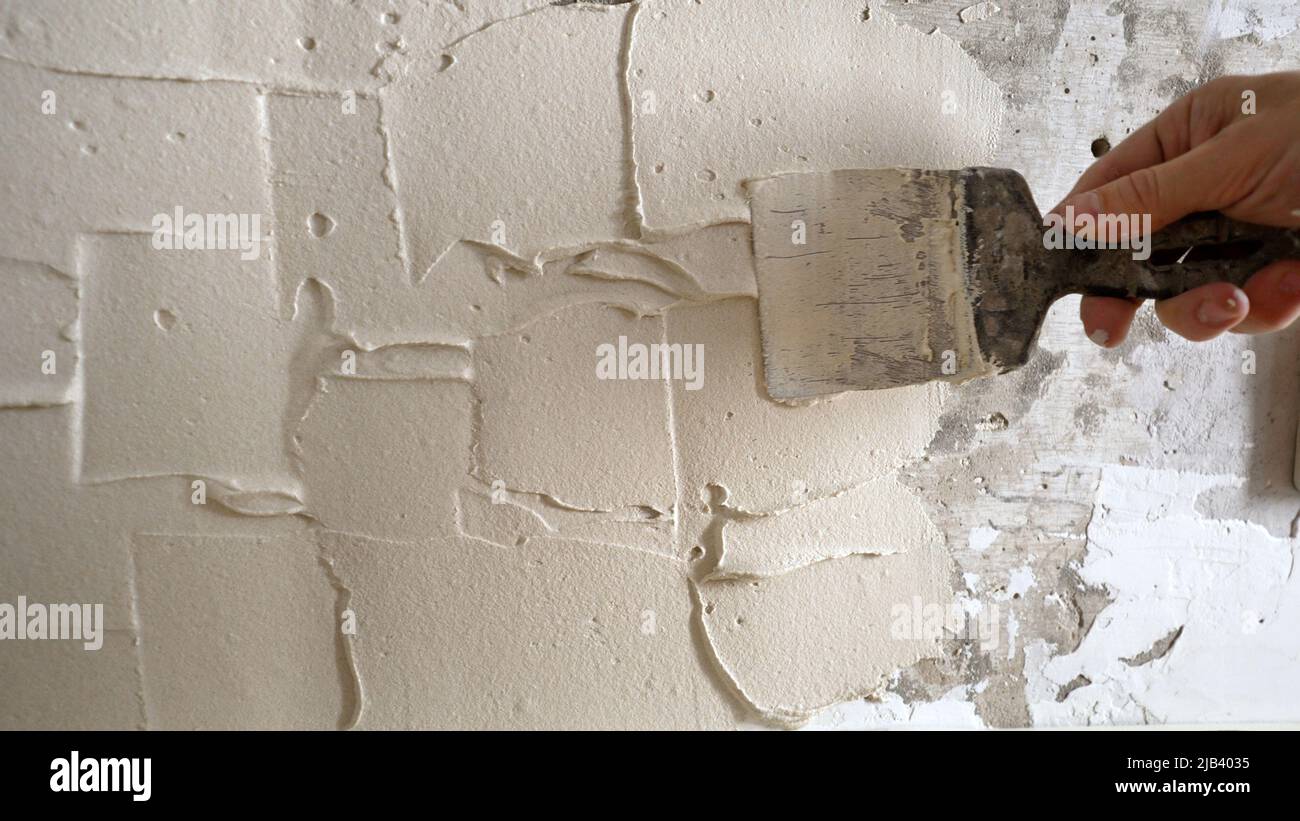 The process of applying plaster adhesive for ceramic tiles. The tile is ...
