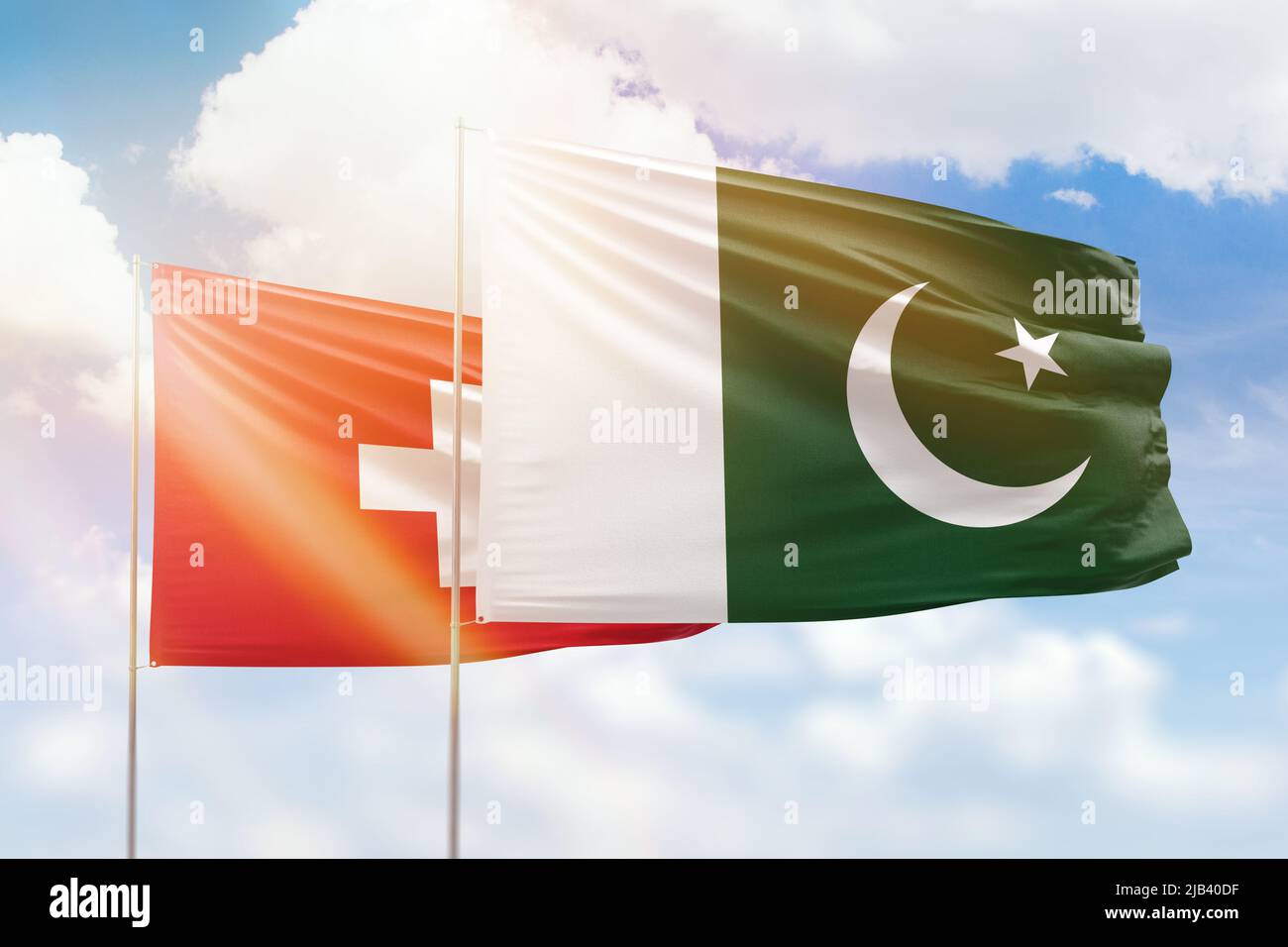 Sunny blue sky and flags of pakistan and switzerland Stock Photo - Alamy