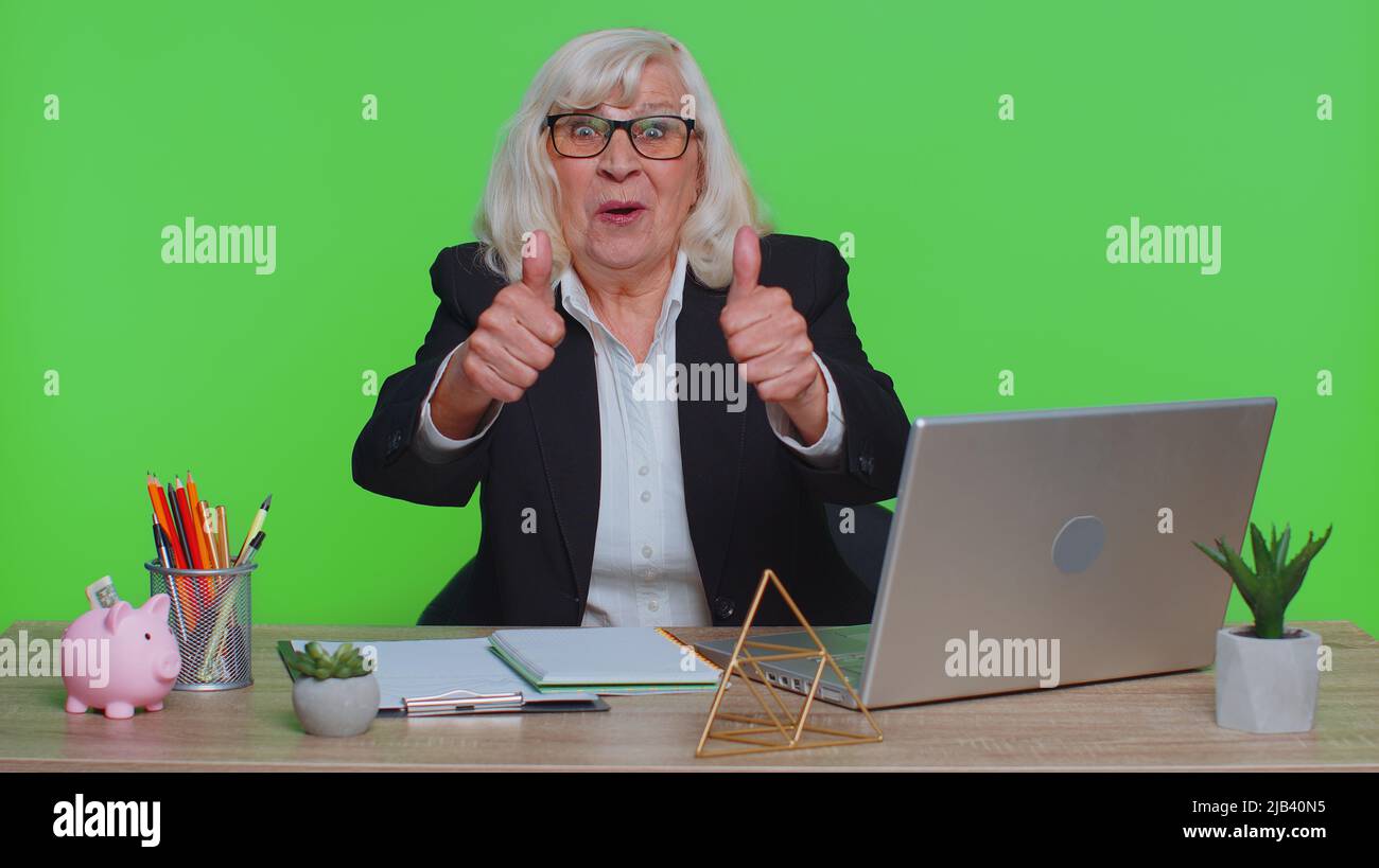 Great, nice good job. Senior businesswoman showing thumbs up and ...
