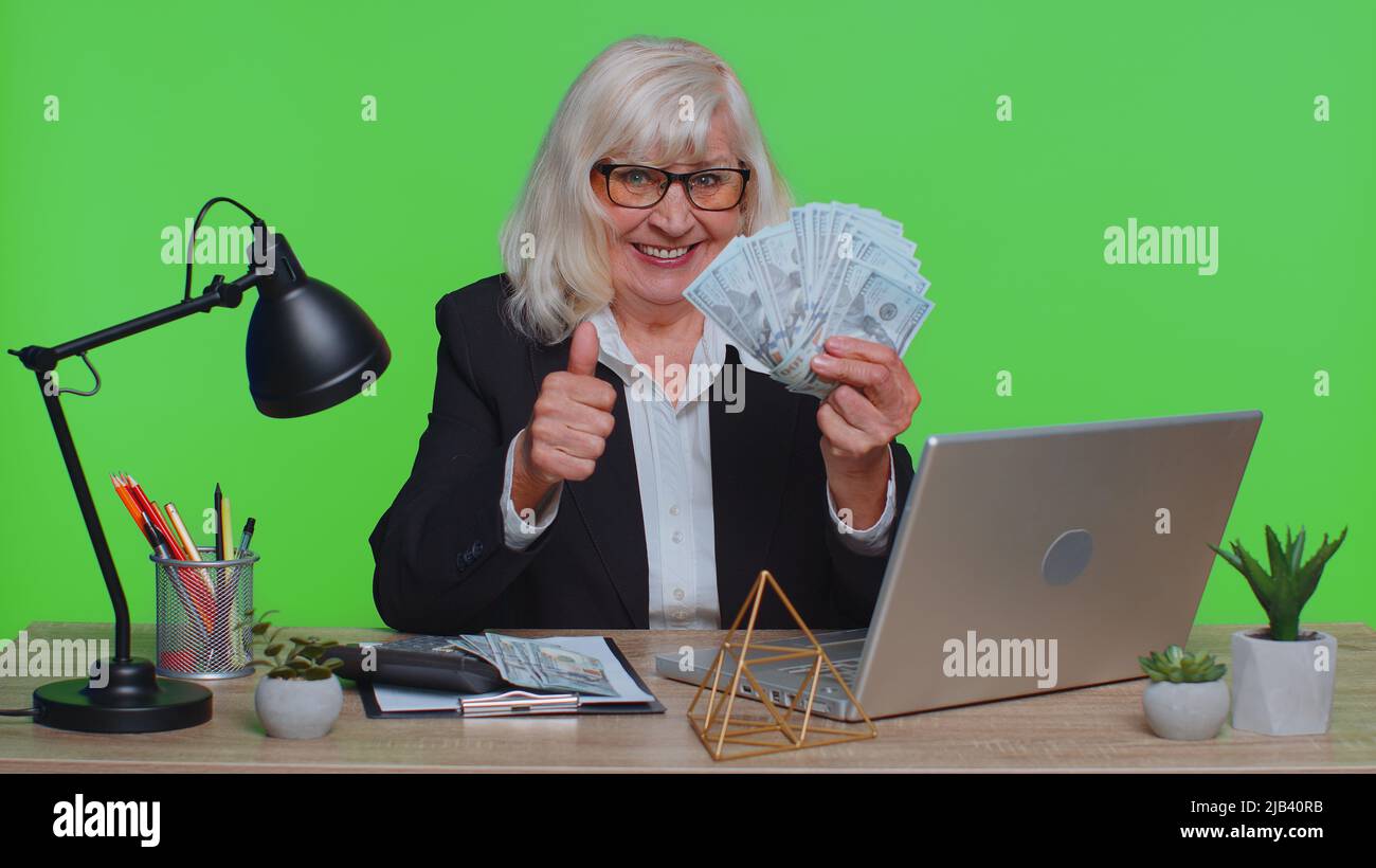 Senior old business woman accountant wears glasses, formal suit ...