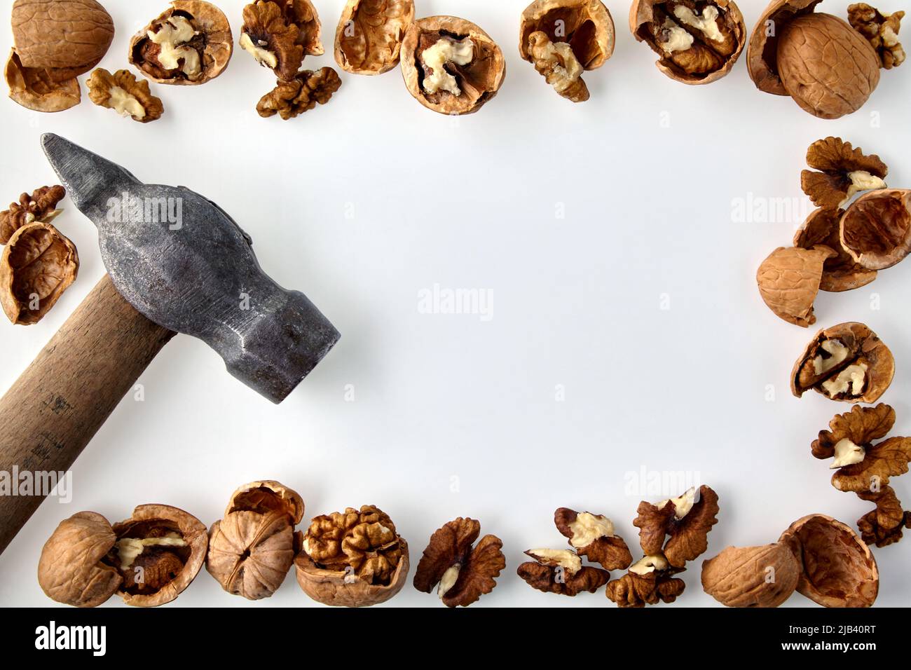 A frame made of chopped walnuts and a hammer. Tough problem concept ...