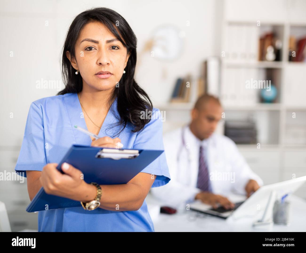 Portrait of female therapist with folder for papers Stock Photo - Alamy
