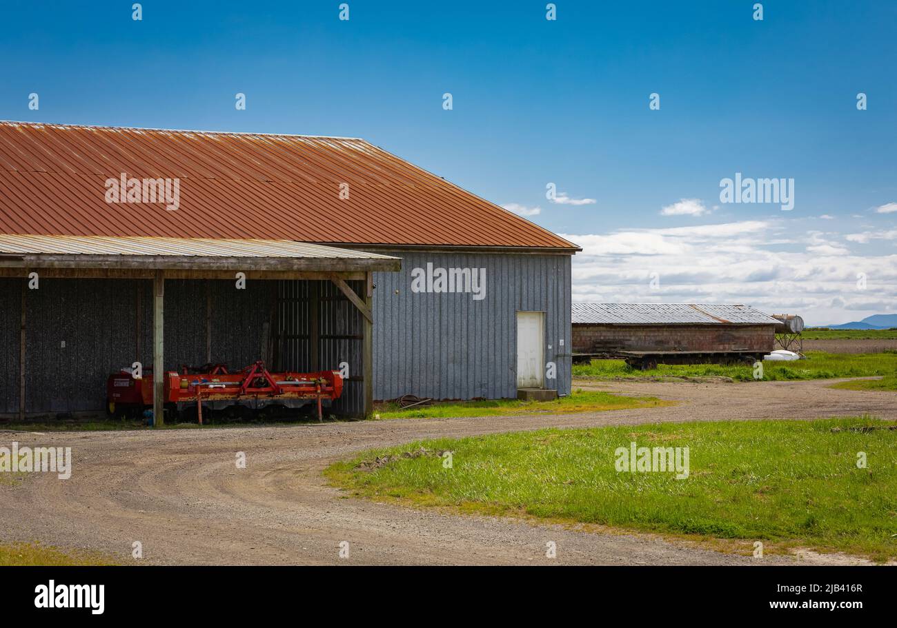 Typical barn in a farm in overcast day in Canada. Street view, travel ...