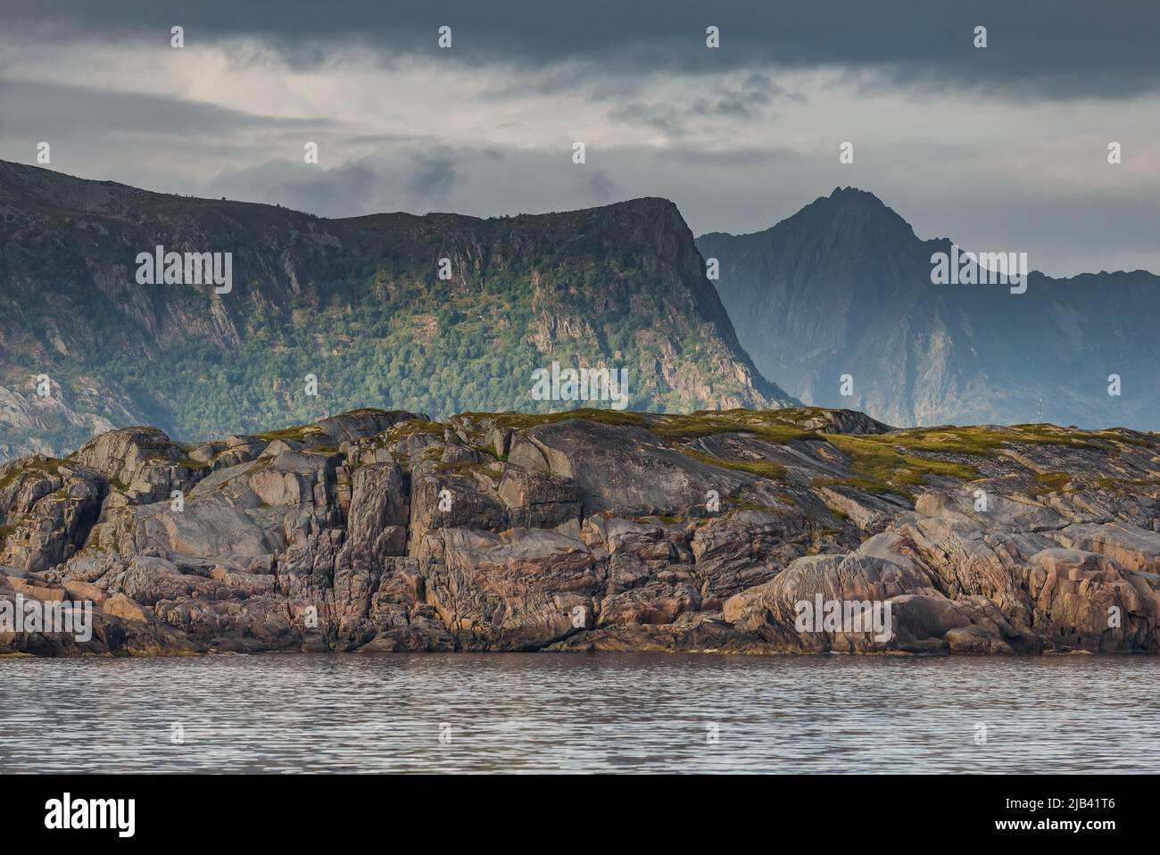 Norwegian seascape, rocky coast with dramatic skies, the sun breaks ...