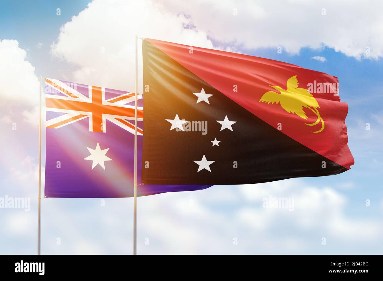 Sunny blue sky and flags of papua new guinea and australia Stock Photo ...