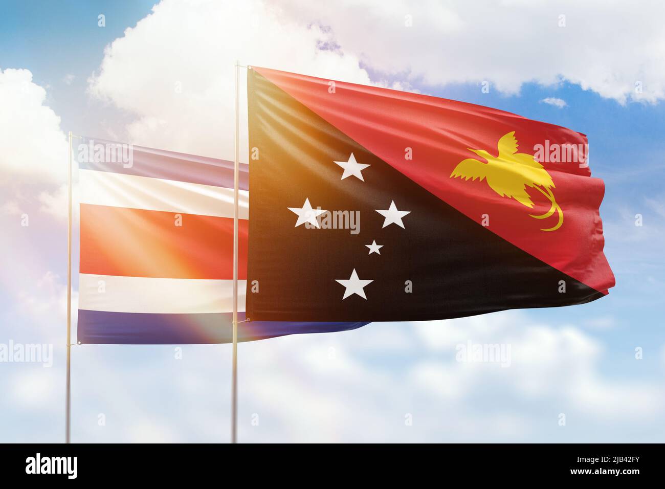 Sunny blue sky and flags of papua new guinea and costa rica Stock Photo ...