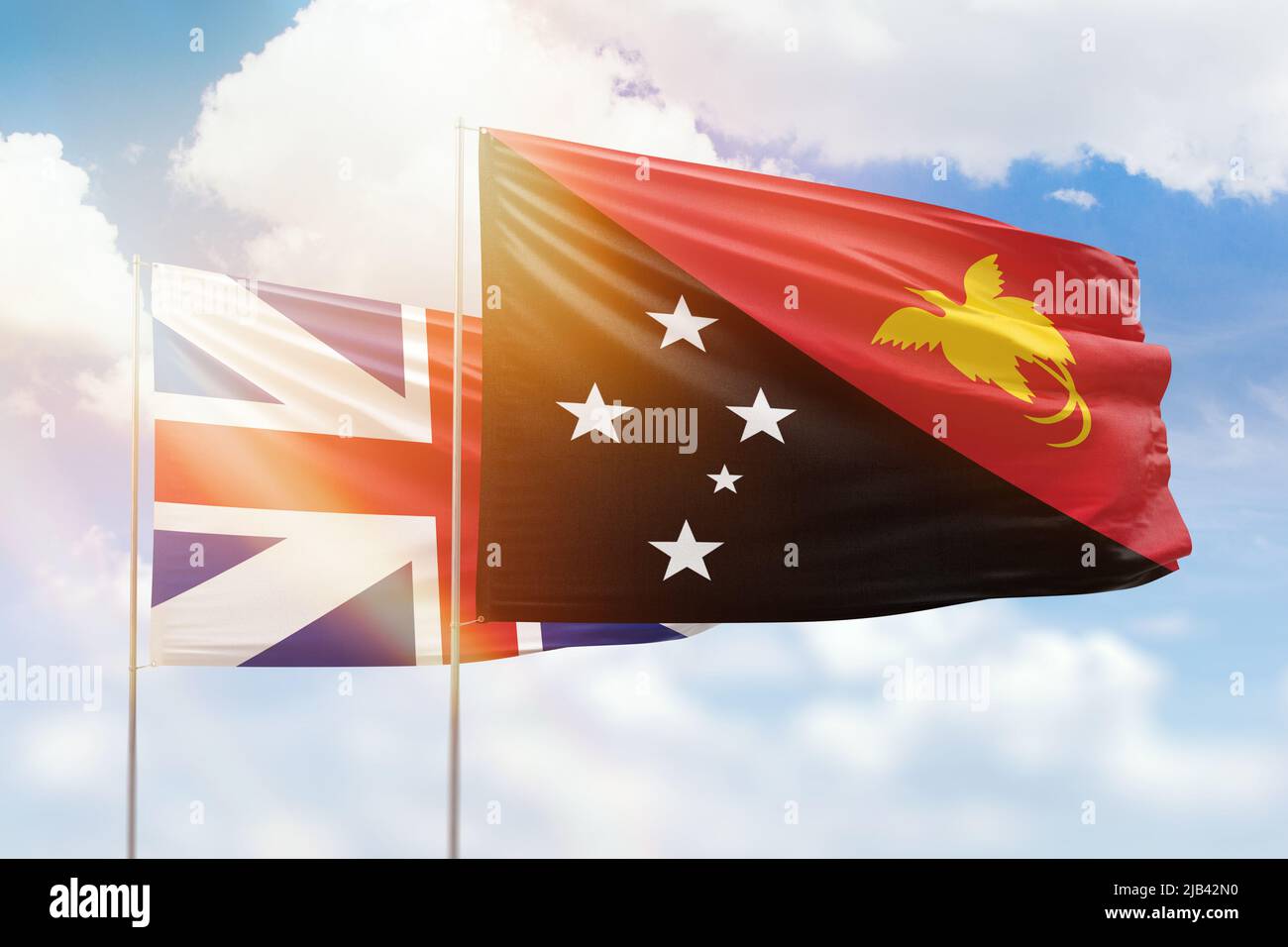 Sunny blue sky and flags of papua new guinea and great britain Stock ...
