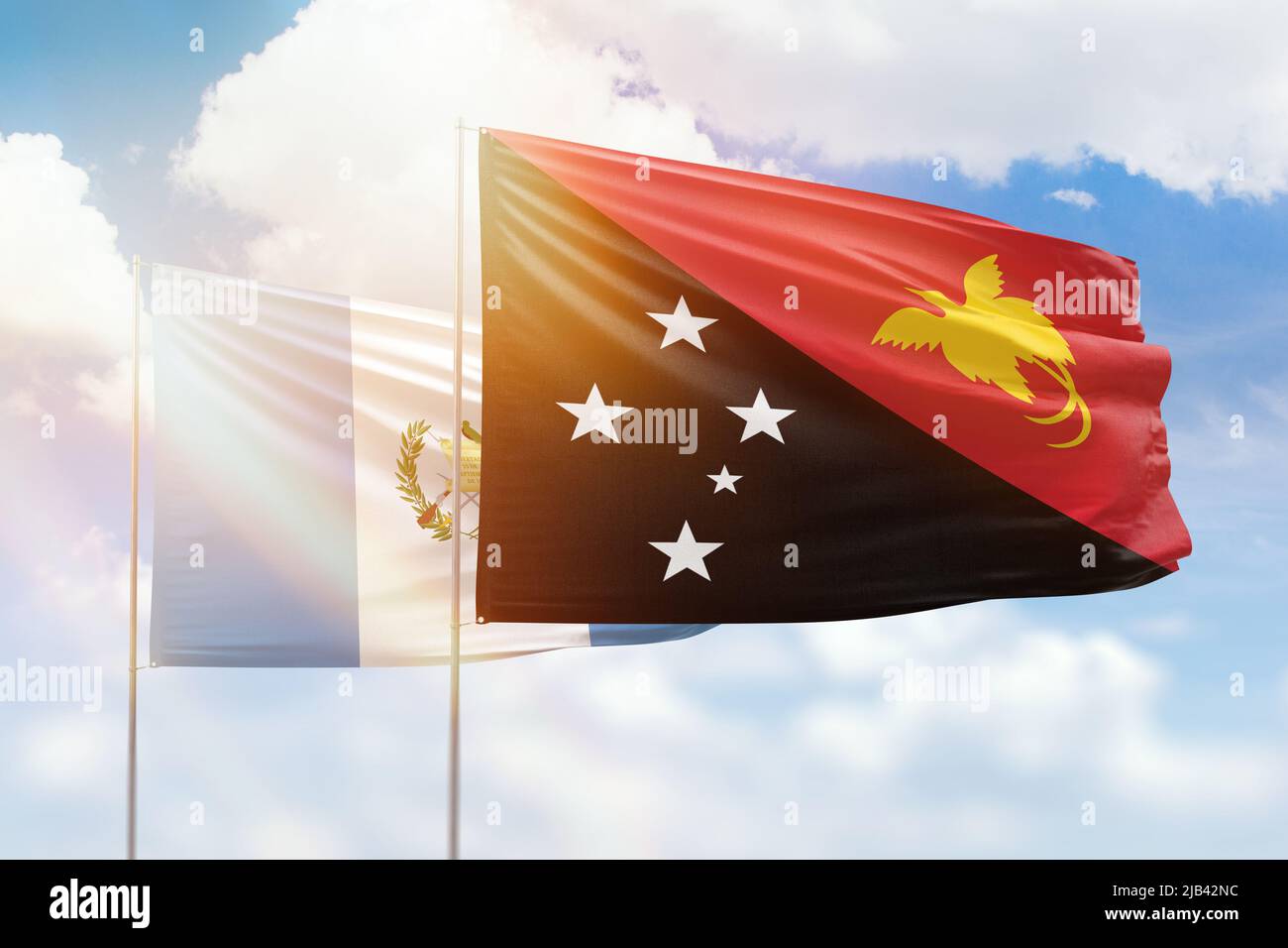 Sunny blue sky and flags of papua new guinea and guatemala Stock Photo ...